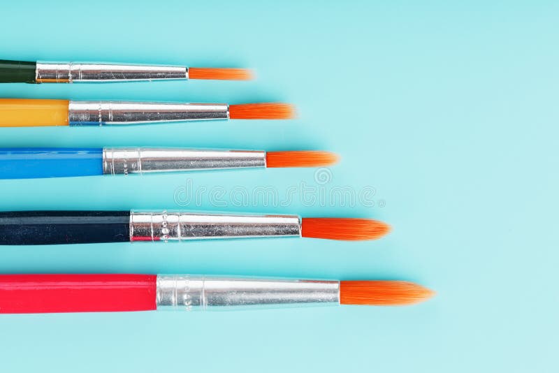 Multi-colored Brushes for Drawing and Art on a Blue Background Stock ...