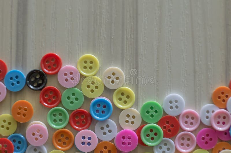 A Multi Colored Buttons on Light Wood Table Stock Photo - Image of ...
