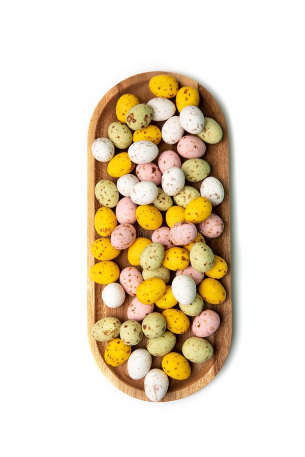 Multi-colored Chocolate Decorative Eggs in Wooden Plate on a White ...