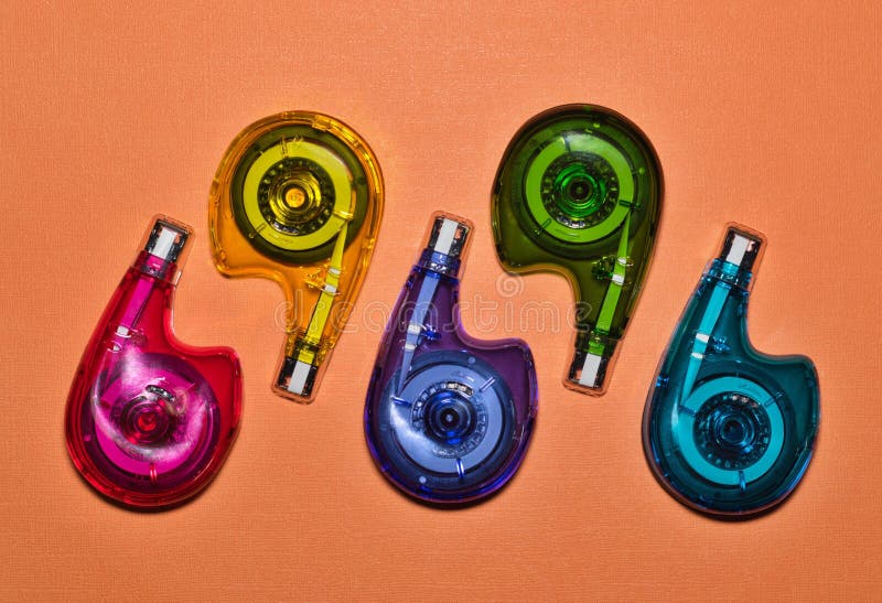 Multi Colored Correction Tape Dispensers on Orange Background. Stock ...