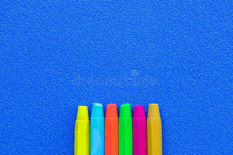 Multi-colored Crayons on Blue Board. Top View Stock Photo - Image of ...