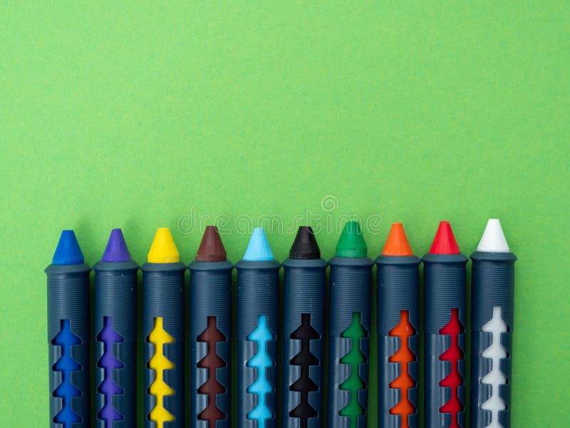 Multi-colored Crayons for Drawing on a Green Background. Stock Image ...