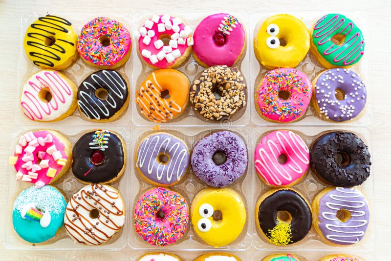 Colored Donuts With Colorful Sprinkles And Coconut On Pink Background ...