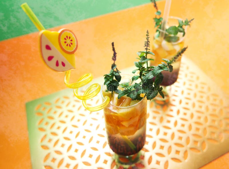Multi-colored Drinks with Pieces of Fruit, Mint and an Unusual Straw ...