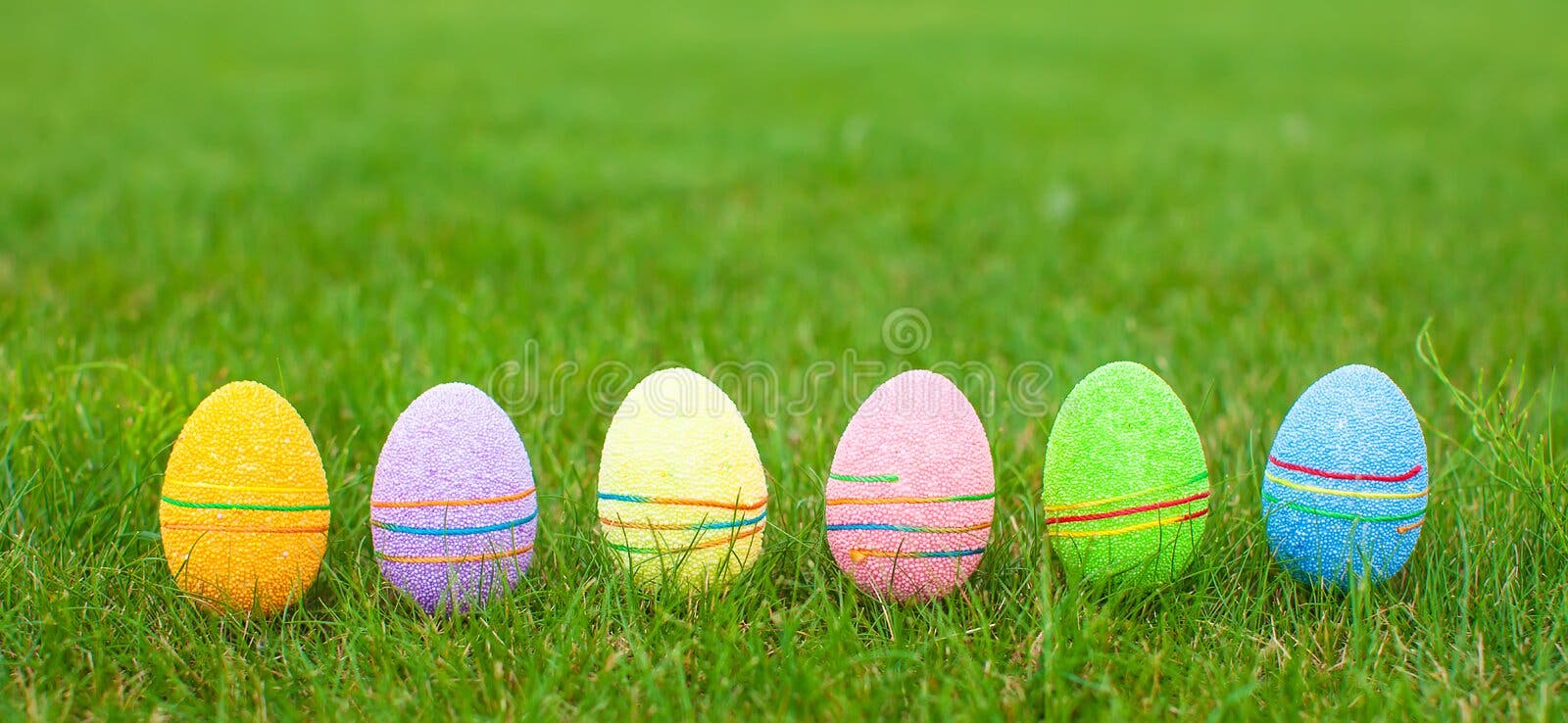 Colorful Easter Eggs in a Field of Grass Stock Photo - Image of motion ...