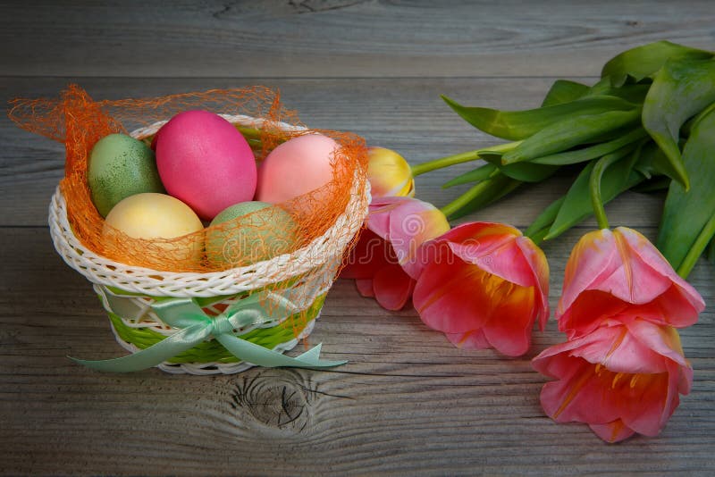 Multi-colored Easter Eggs and Sweets in a Beautiful Basket Stock Photo ...