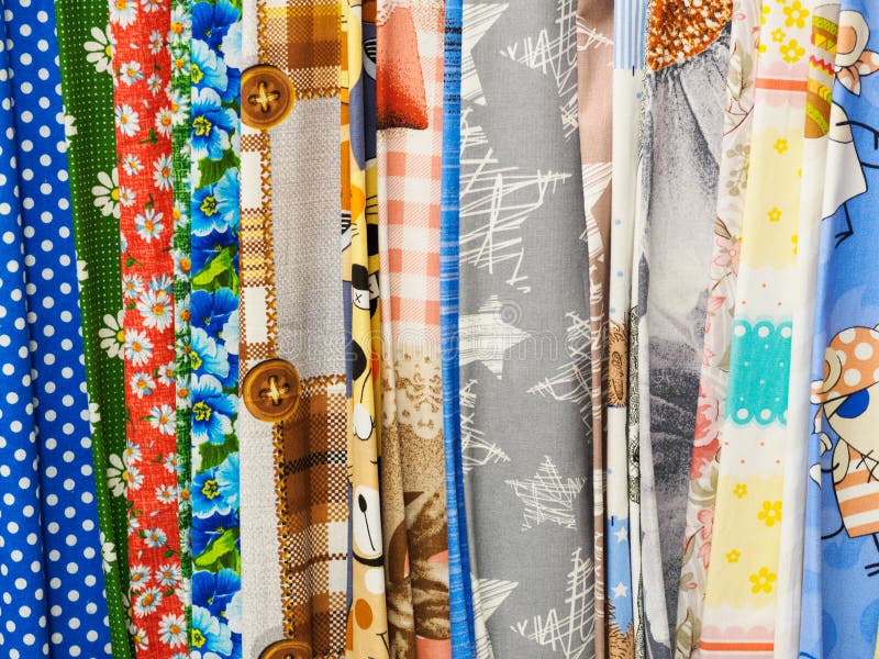 Multi-colored Fabrics with a Pattern Hang for Sale in a Store Stock ...