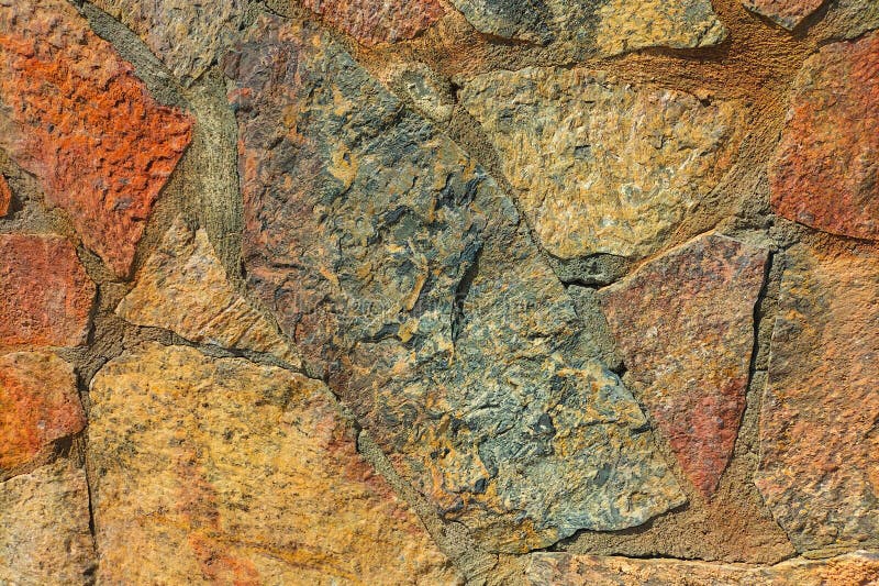 Multi-colored Facade of the Building Wall is Made of Natural Stone, a ...