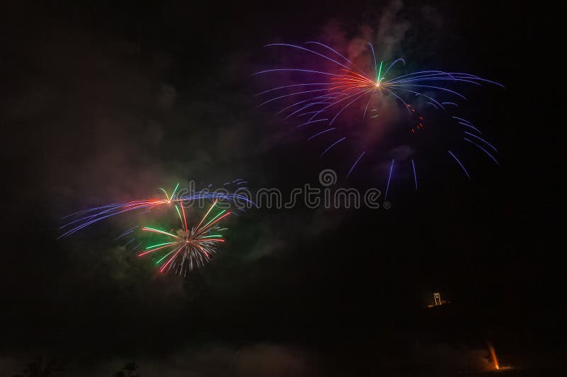 Multi Colored Fireworks Making Wake Effect Over Trees Silhouette Stock ...
