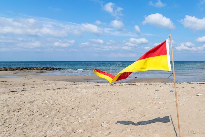 Multi-colored Flag on a Sandy Beach. Denmark. North Sea Stock Photo ...