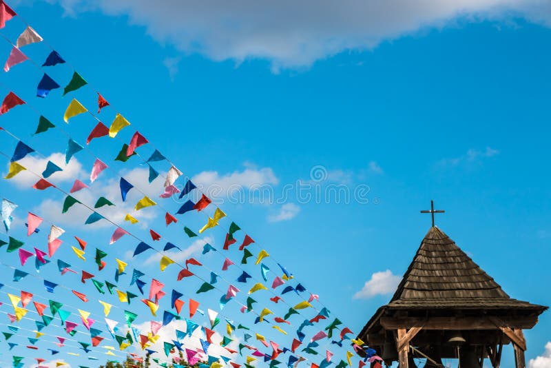Multi-colored Flags Against a Blue Sky with Clouds and a Dome of a ...