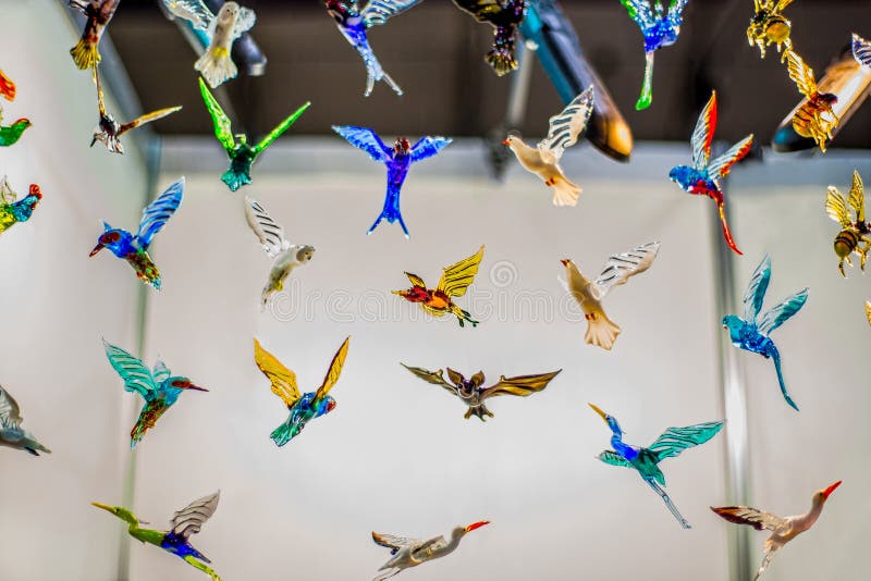 Multi-colored Glass Birds Hang on Strings. Stock Photo - Image of ...