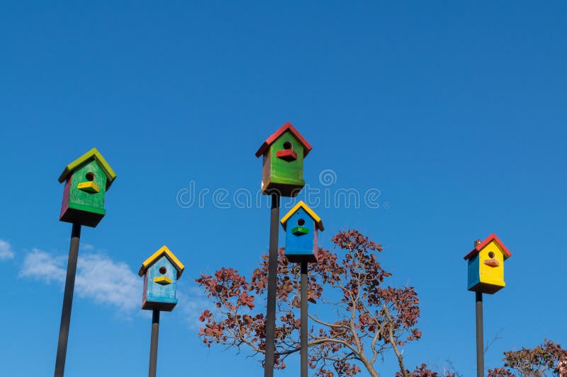 Multi-colored Houses for Birds. Birdhouses Against the Blue Sky Stock ...