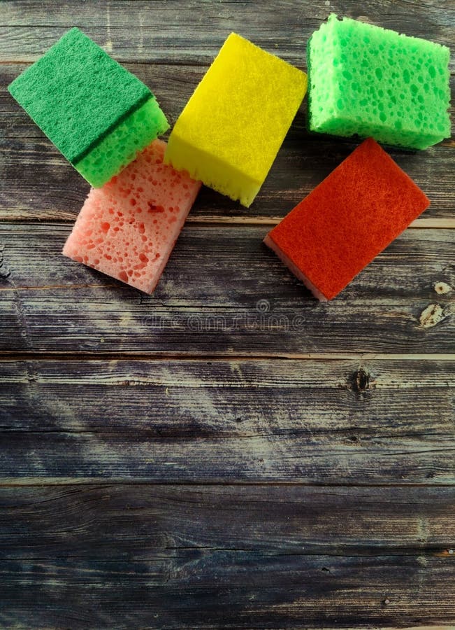 Multi-colored Kitchen Sponges for Washing Dishes on a Wooden Table ...