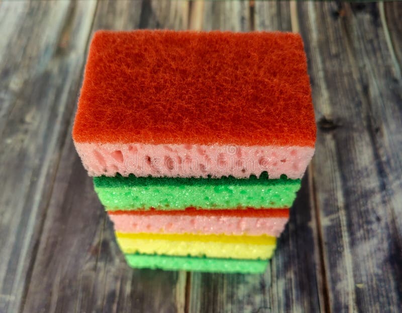 Multi-colored Kitchen Sponges for Washing Dishes on a Wooden Table ...
