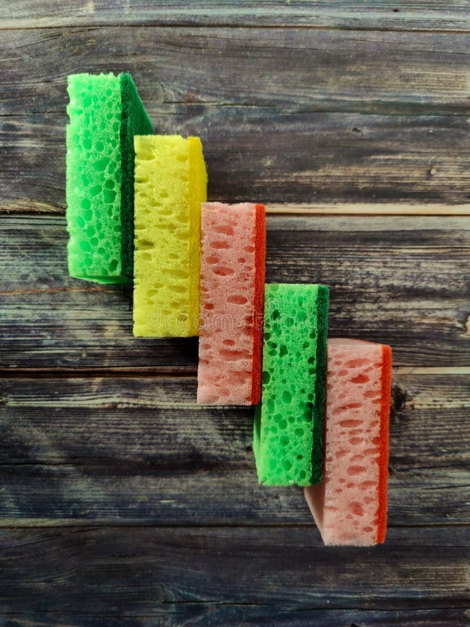 Multi-colored Kitchen Sponges for Washing Dishes on a Wooden Table ...