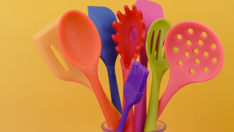 Bright Multi Colored Kitchen Utensils on Yellow Background Stock ...