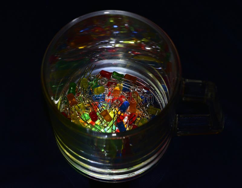 Multi-colored Low-power LEDs are Poured into a Round Glass Container ...