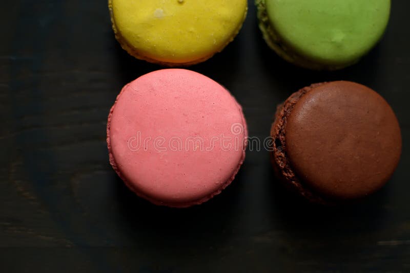 Multi-colored Macaroons on a Wooden Tray. Pink, Yellow and Green ...