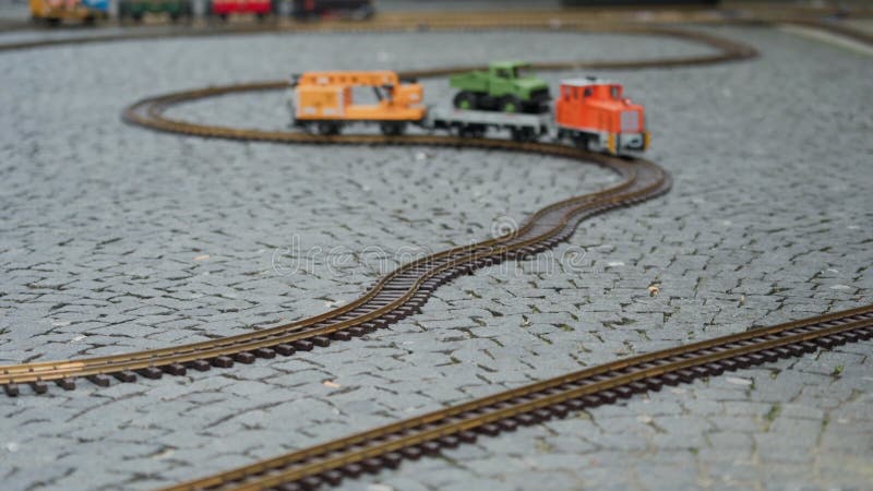 Multi Colored Model of Freight Train Travels Along the Winding Rails of ...