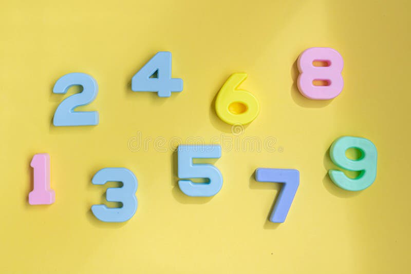 Multi-colored Numbers on a Yellow Background Top View. Child ...
