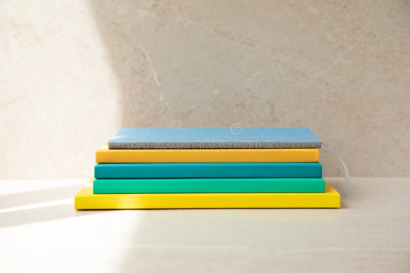 Multi-colored Office Notebooks on a Light Beige Background, Side View ...