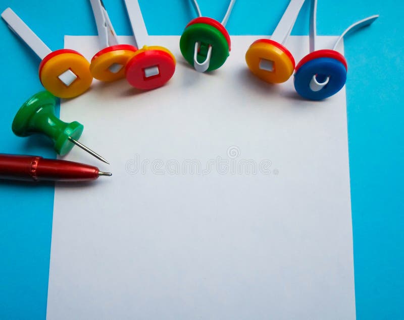 Multi-colored Paper Clips and a White Sheet of Paper with a Red Pen ...