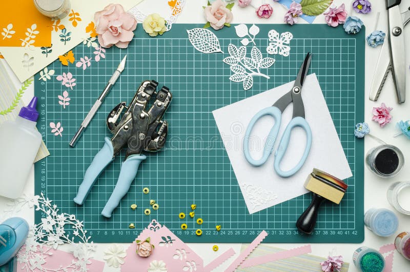 Multi-colored Paper Crafts on the Cutting Mat and Scrapbooking Tools ...