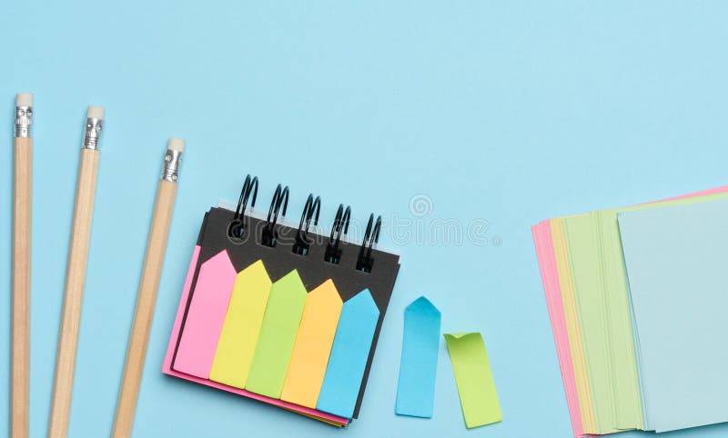 Multi-colored Paper Sticky Notes on a Blue Background Stock Image ...