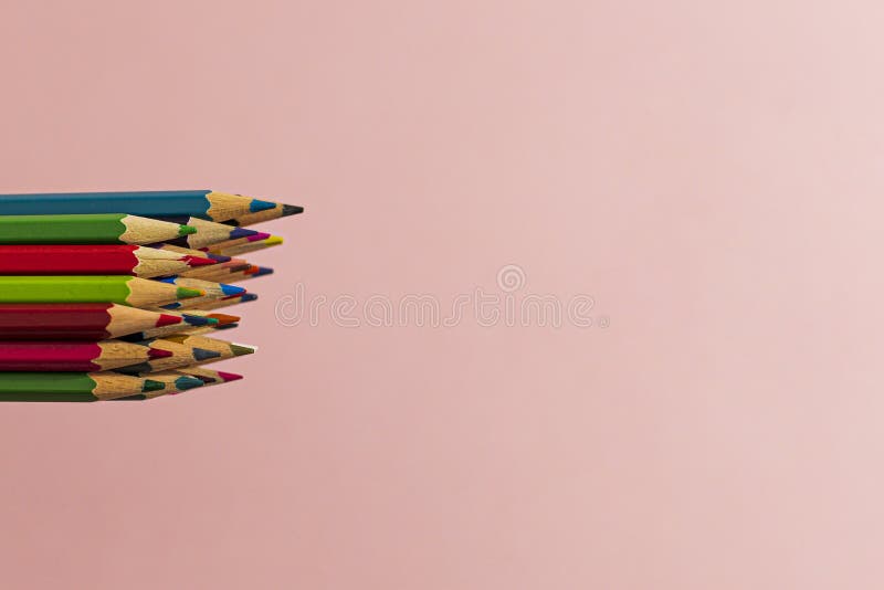 Multi-colored Pencils Located Together in the Left Side on a Pink ...