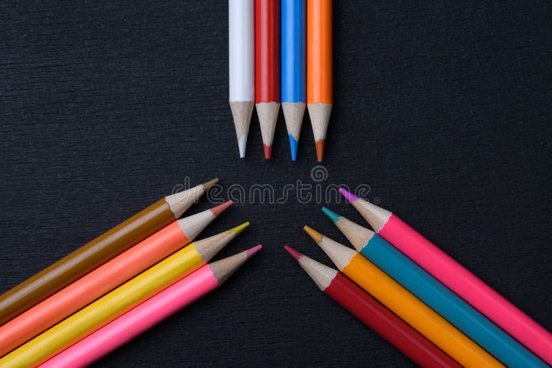 Colored Pencils Lie on a Black Background in a Triangle Stock Photo ...