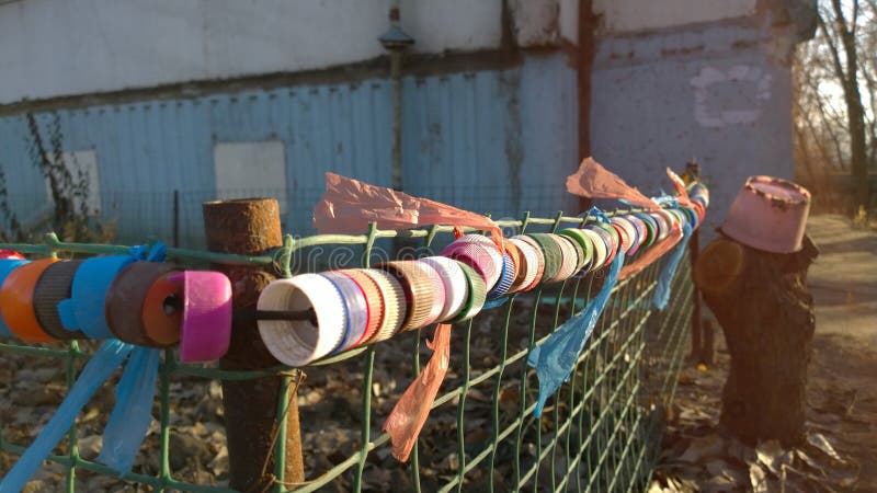 Multi-colored Plastic Bottle Caps Hang on the Fence Stock Photo - Image ...