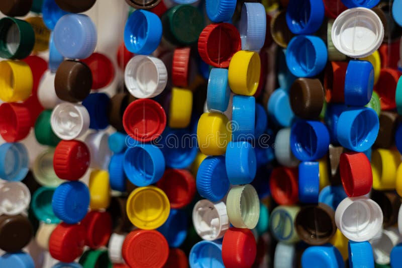 Multi-colored Plastic Caps Hang in a Row on a Thread To Form a ...