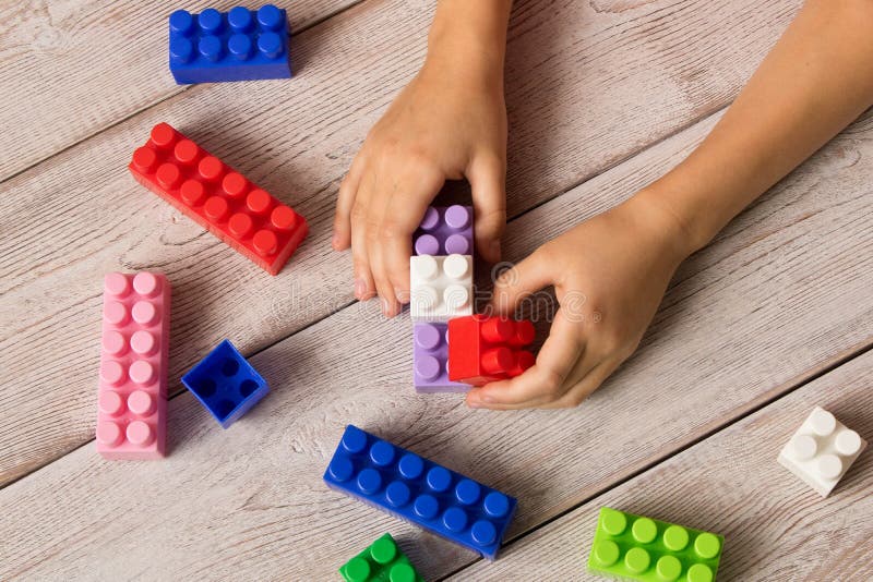 Multi-colored Plastic Constructor in the Hands of the Girl. Children`s ...