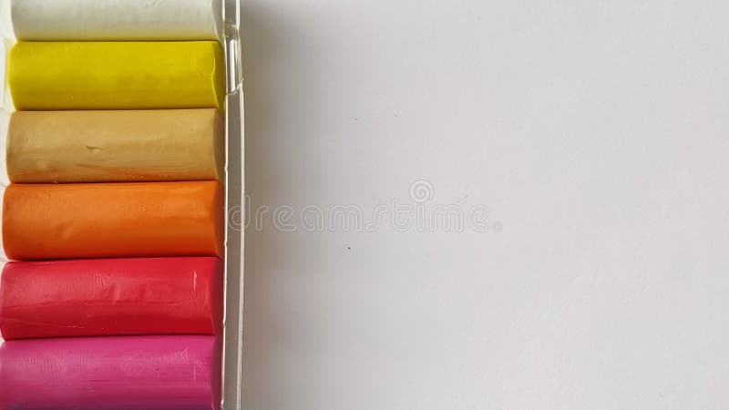 Multi-colored Plasticine in Plastic Packaging on a White Background ...