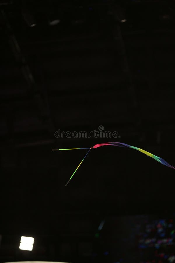 Multi-colored Ribbon for Rhythmic Gymnastics Flies on a Black ...