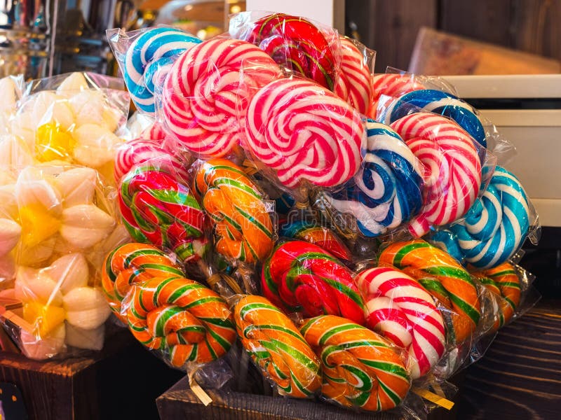 Multi-colored Round Lollipops in Plastic Packaging on the Showcase of a ...
