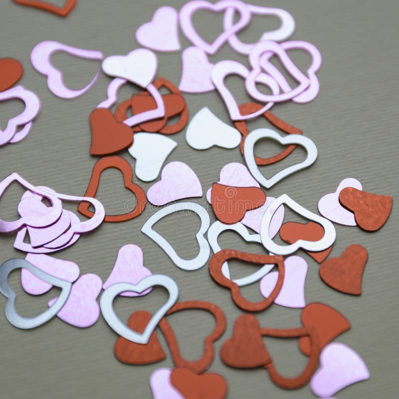 Multi Colored Sequins in the Shape of a Heart on a Beige Background ...