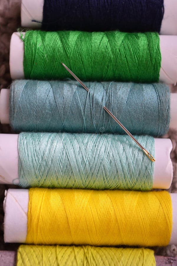 Multi-colored Sewing Threads and a Needle Stock Photo - Image of ...