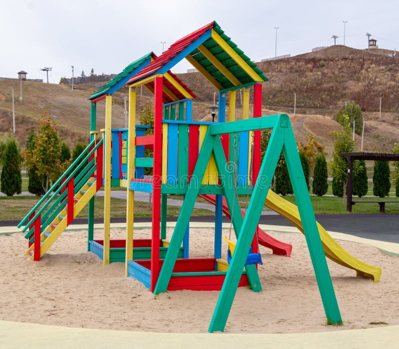 Multi-colored Slides and Swings on Playground. Stock Image - Image of ...