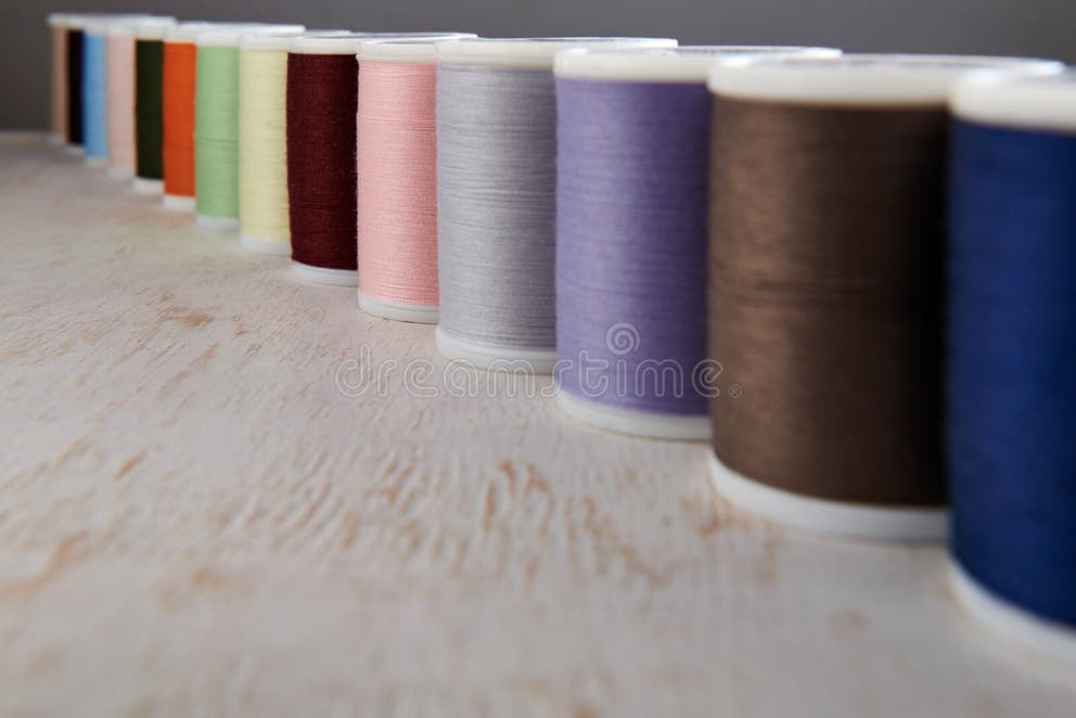 Multi-colored Spools of Threads Standing in a Row Stock Image - Image ...