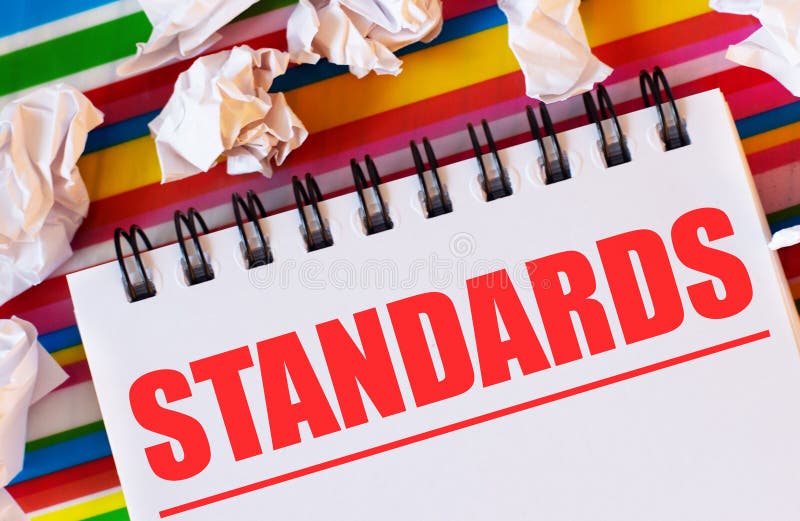 On a Multi-colored Striped Background There are White Pieces of Paper ...