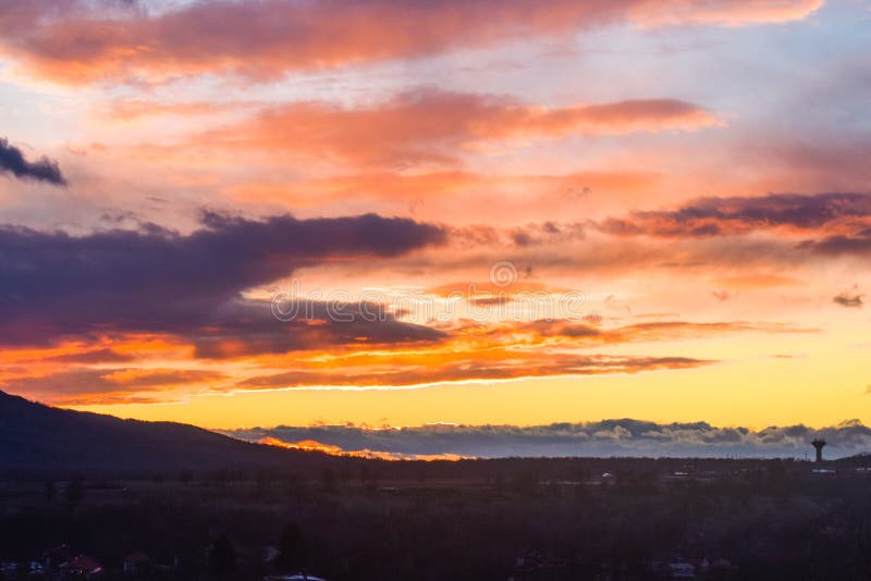 Multi Colored Sunset with a Silhouette Tree Line and Fire Clouds Stock ...