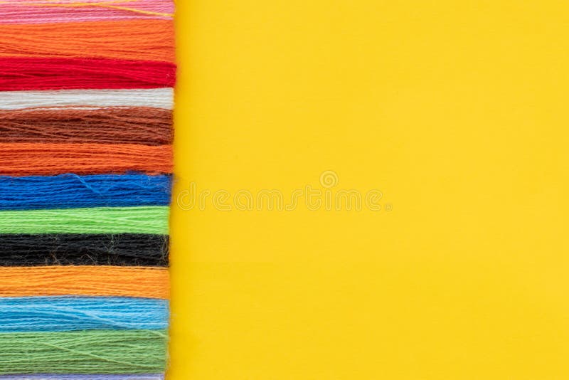 Multi-colored Thread for Embroidery is Laid Out in a Row on a Yellow ...