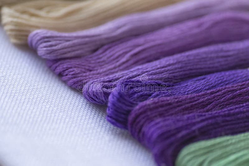 Multi-colored Threads for Embroidery on Blue Canvas. Place for Text ...