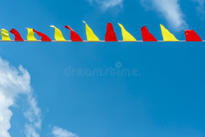 Multi Colored Triangular Flags Develop on the Background of Blue Sky ...
