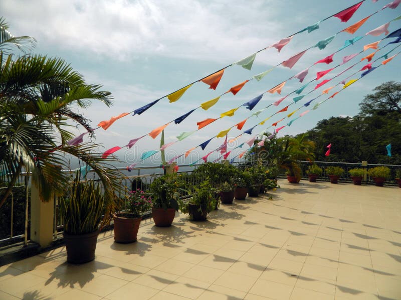 Multi-colored Triangular Flags Flutter Over an Open Terrace Stock Image ...