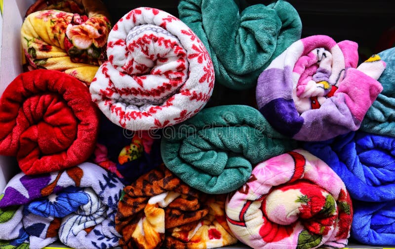 Multi Coloured Bed Blankets Roll in Shelves Stock Image - Image of blue ...