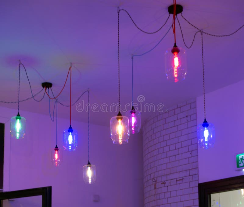 Multi-coloured Bulbs Hanging from a Ceiling and Glowing Stock Photo ...