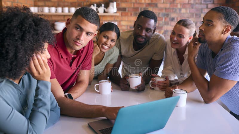 Multi-Cultural Business Team Looking at Laptop during Coffee Break in ...